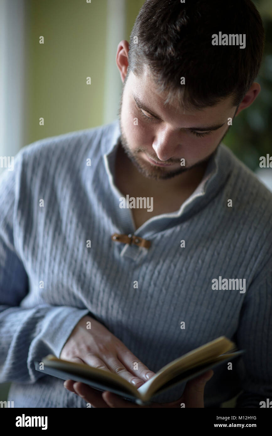 Young man enjoying a great book Stock Photo - Alamy