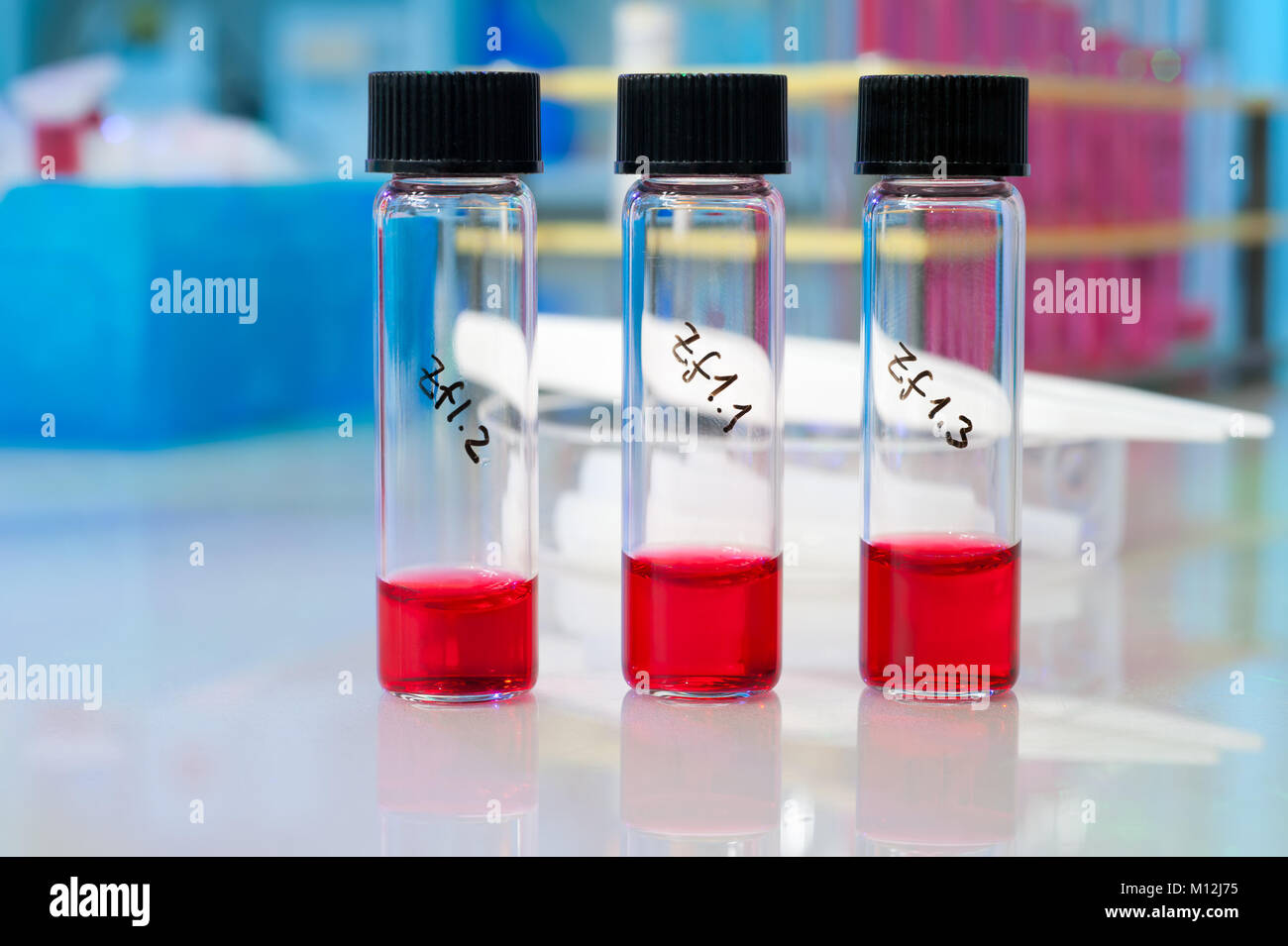 Three liquid samples in plastic vials on a table in biological ... Three liquid samples in plastic vials on a table in biological ...