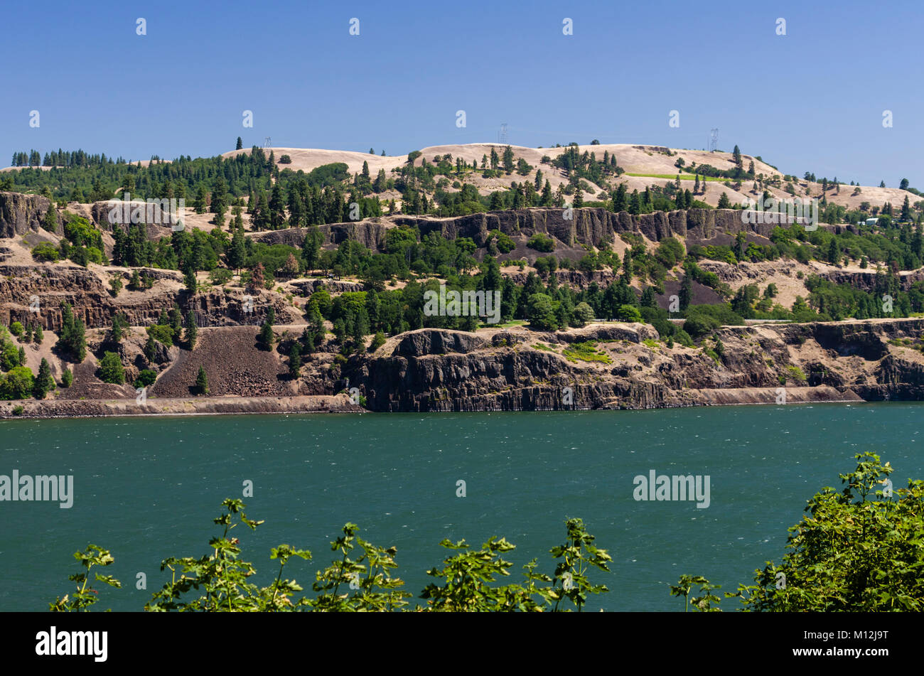 Basalt cliffs rise from the flowing Columbia RIver Stock Photo - Alamy
