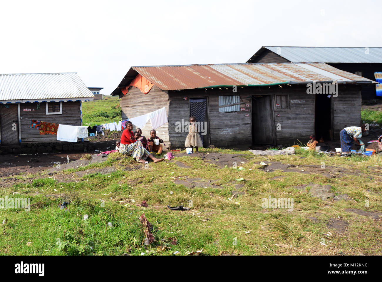 Sitting outside their home in Eastern Congo Stock Photo - Alamy
