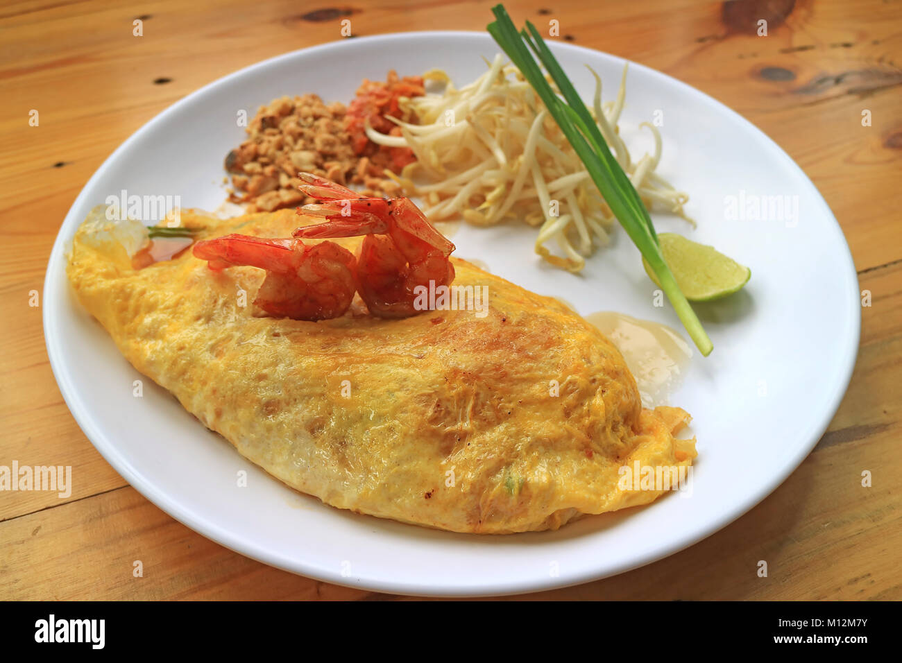 Plate of Fried Egg Wrapped Pad Thai Noodle Topped with Shrimps Served ...