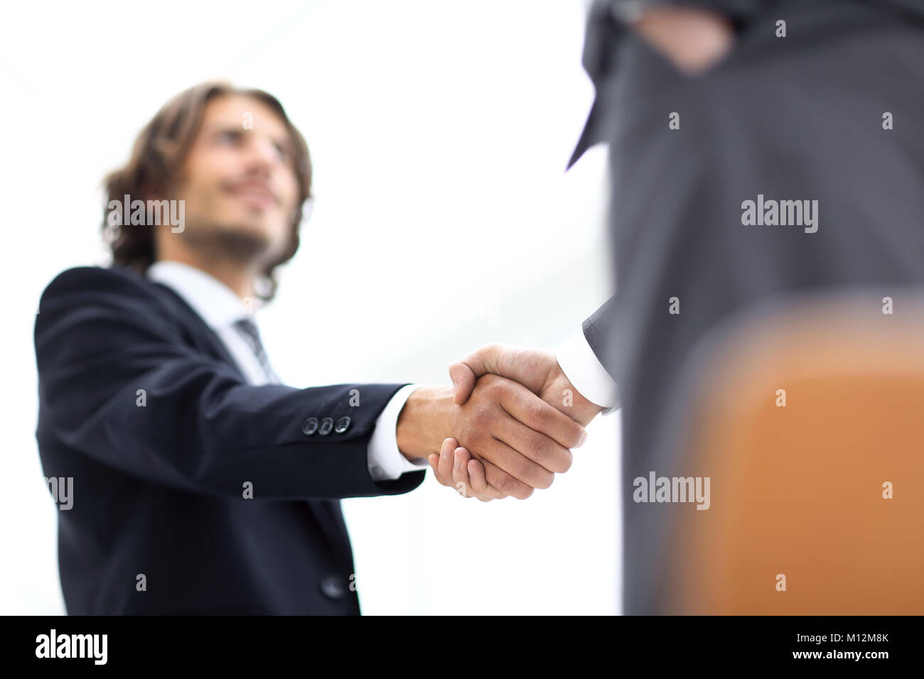 Two businessman shaking hands greeting each other Stock Photo - Alamy