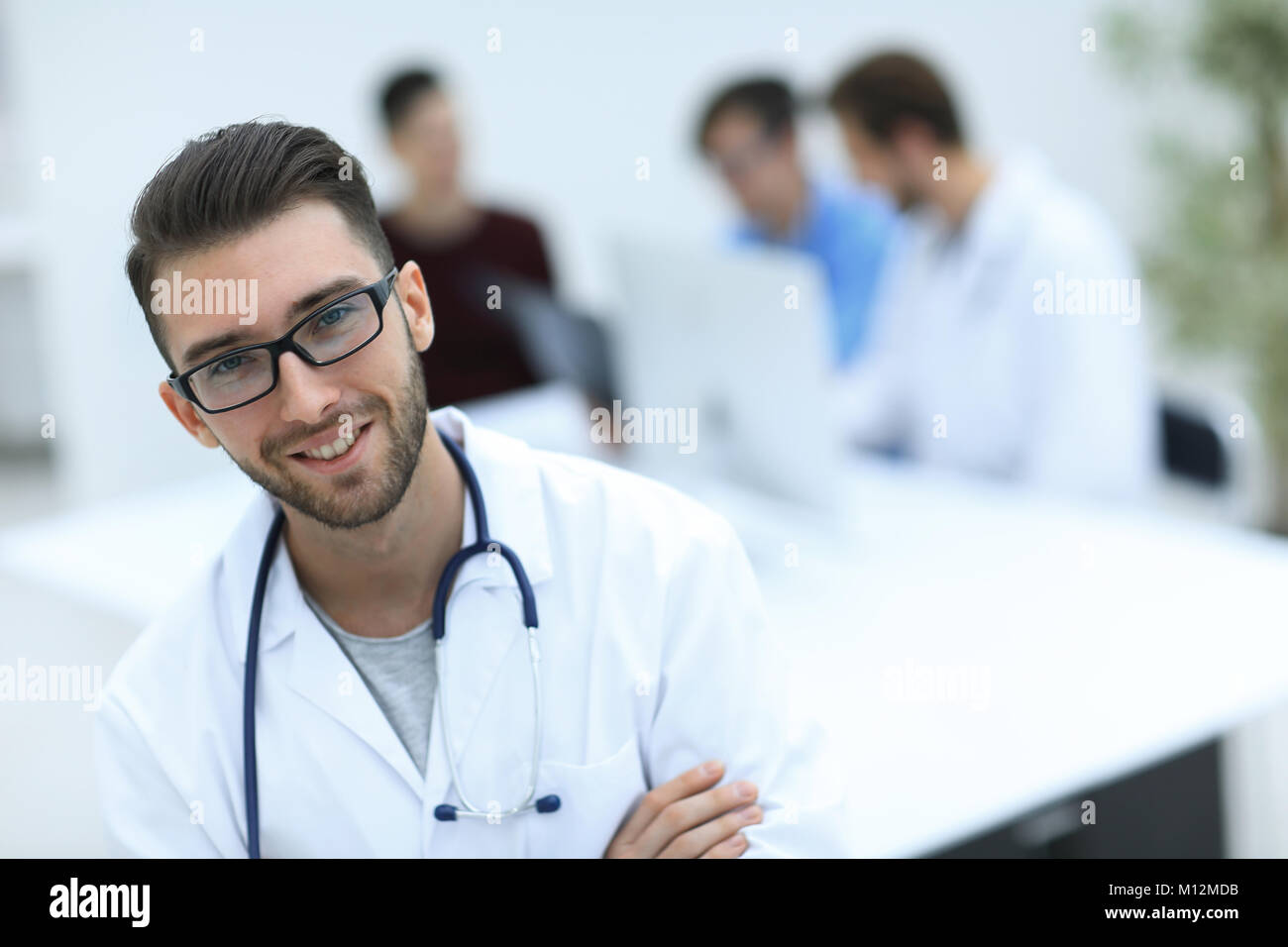 handsome doctor on blurred background Stock Photo - Alamy