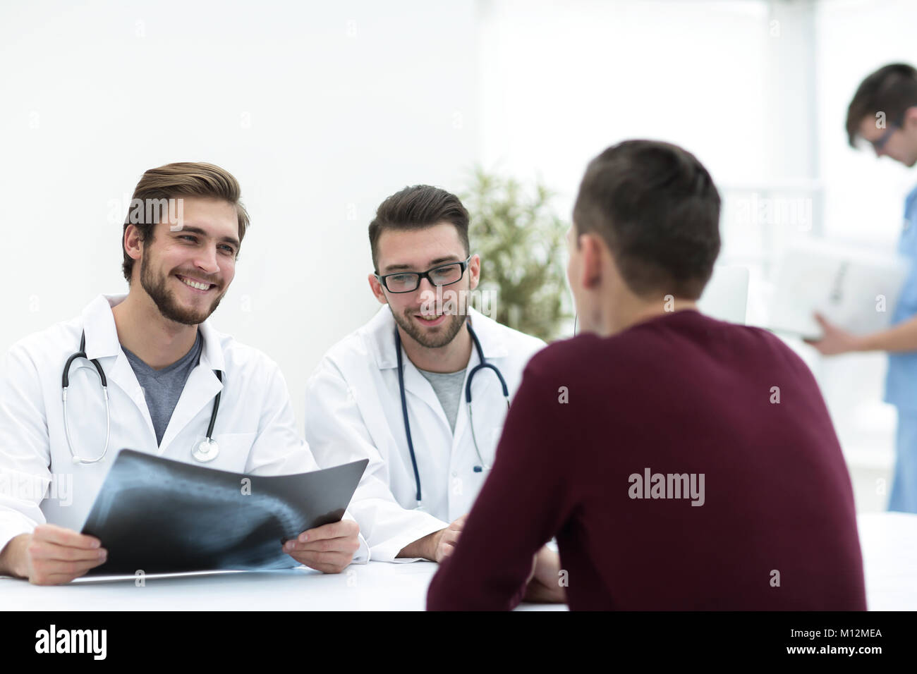 group of doctors welcoming their customer with a handshake Stock Photo ...