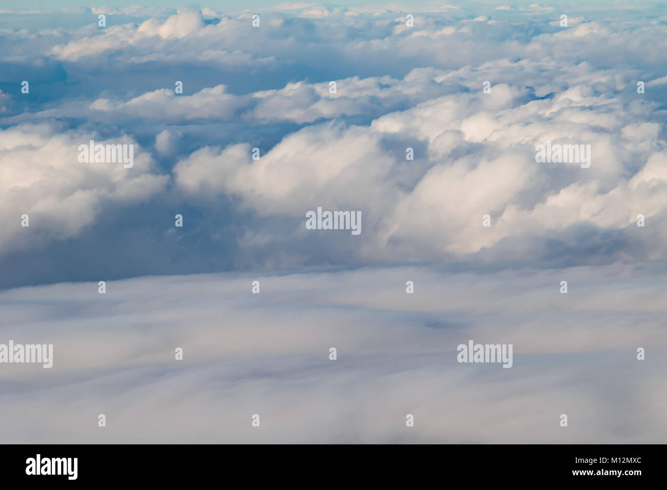 Rolling fluffy clouds coming together to for a cloud blanket in the ...