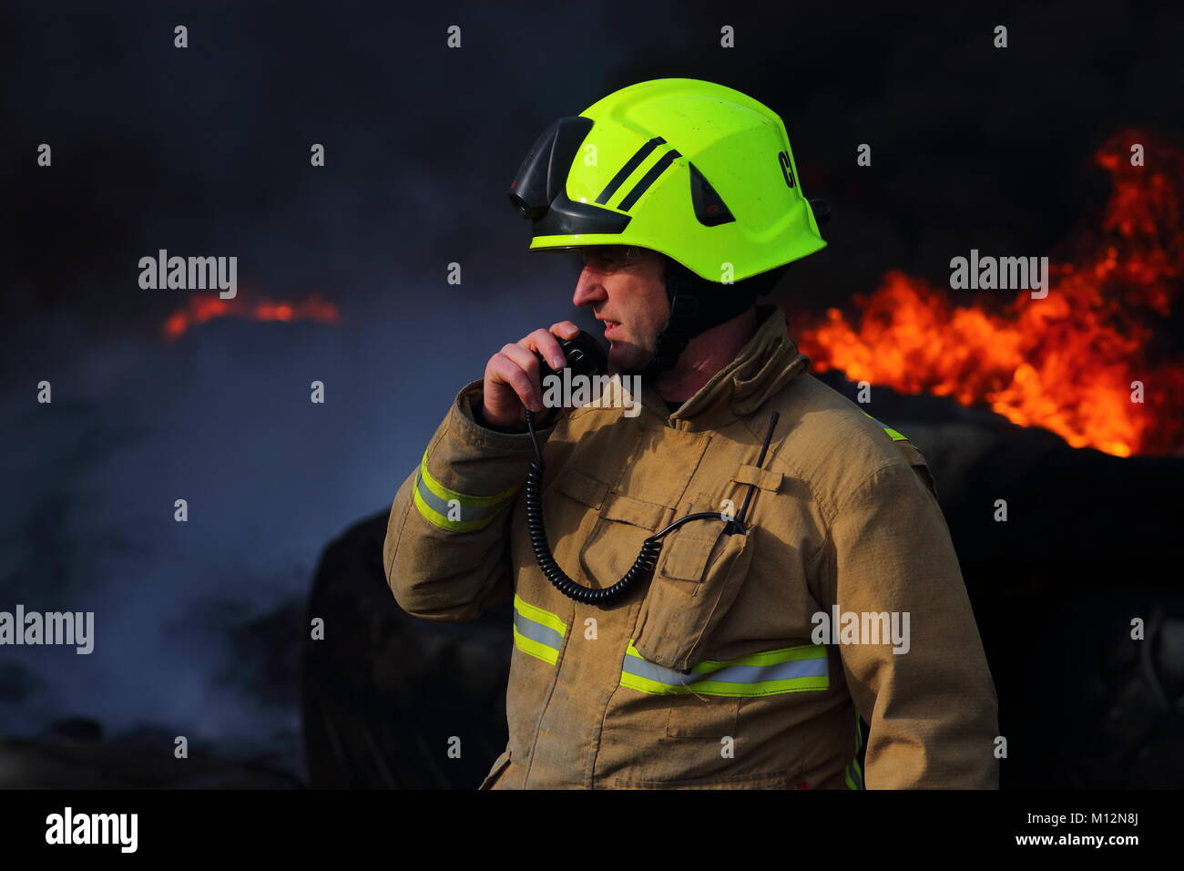 Fireman In Action Stock Photo - Alamy