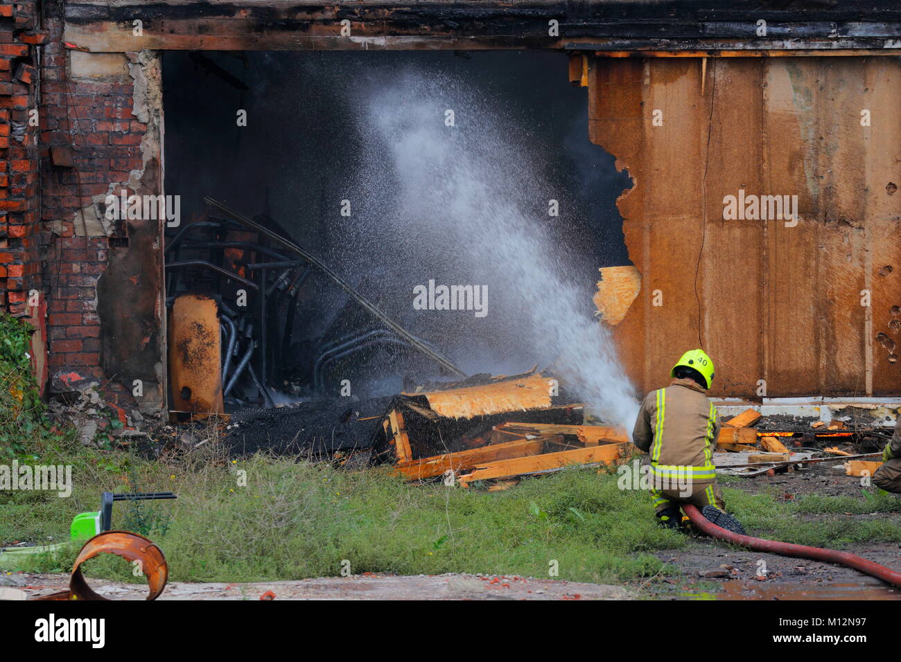 Firemen using hose hi-res stock photography and images - Alamy