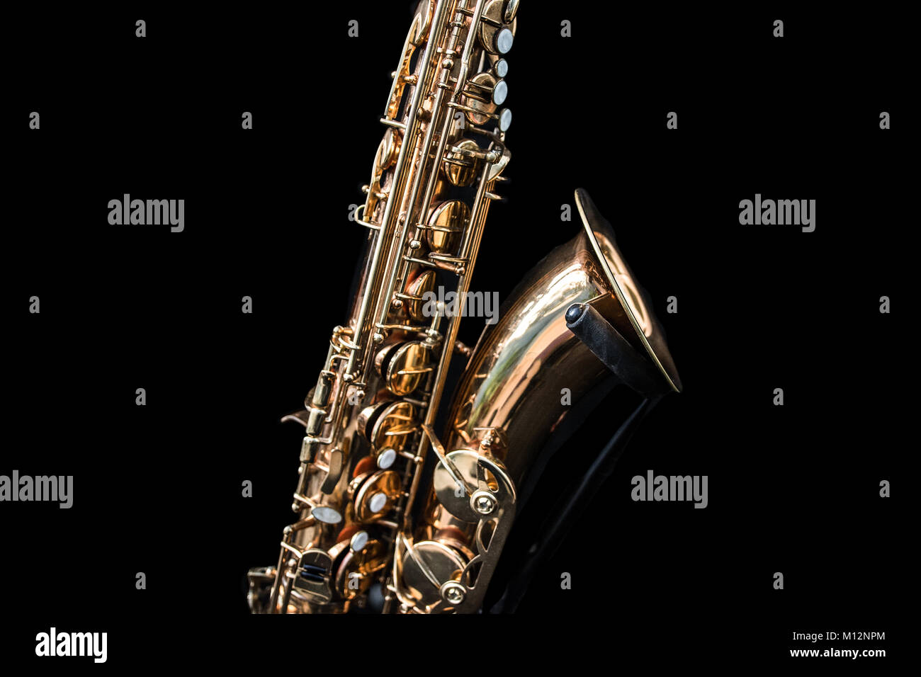 Close up of a standing golden saxophone isolated in black Stock Photo ...