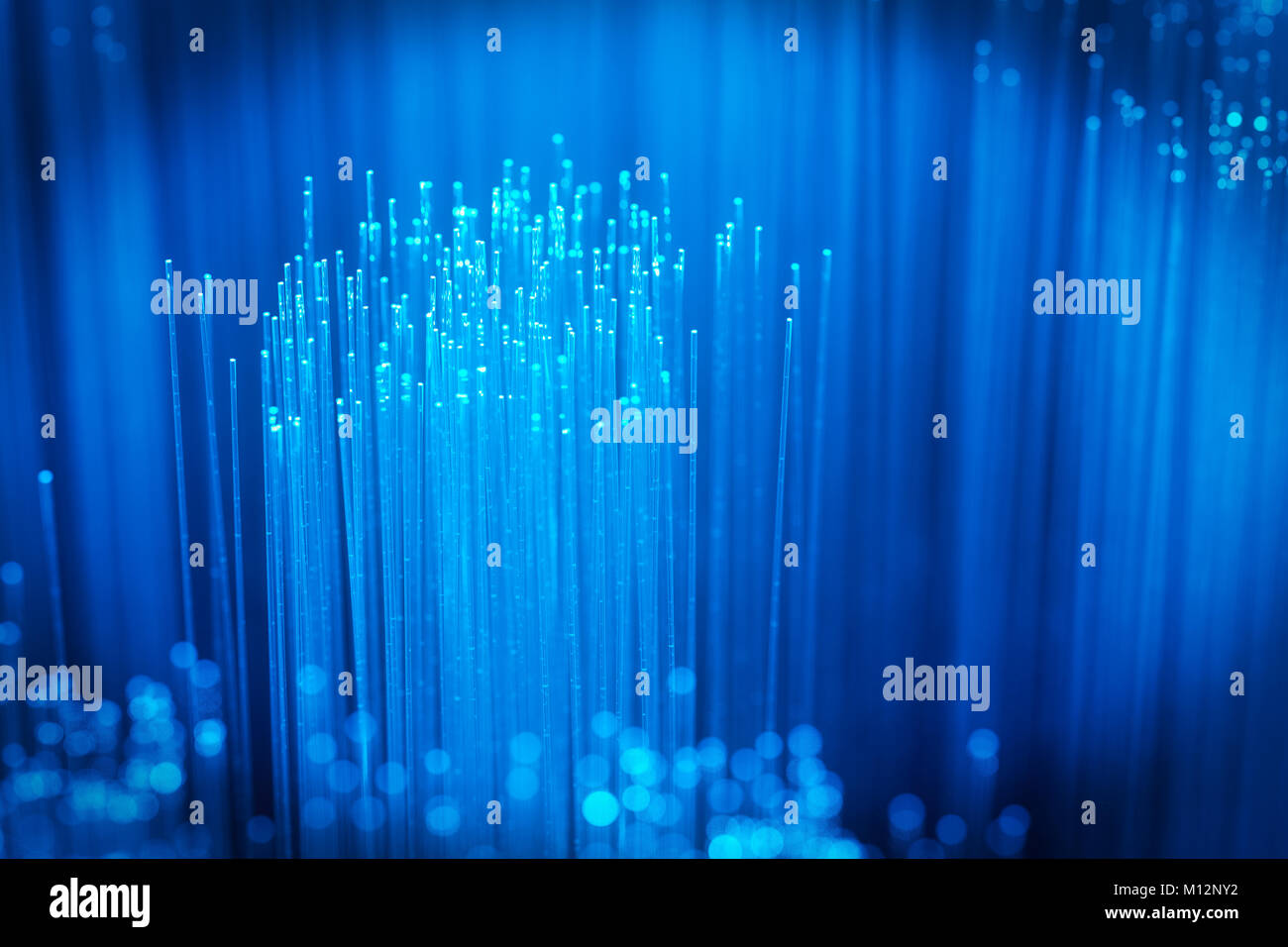 3d rendering of fiber optics against blue light background Stock Photo ...