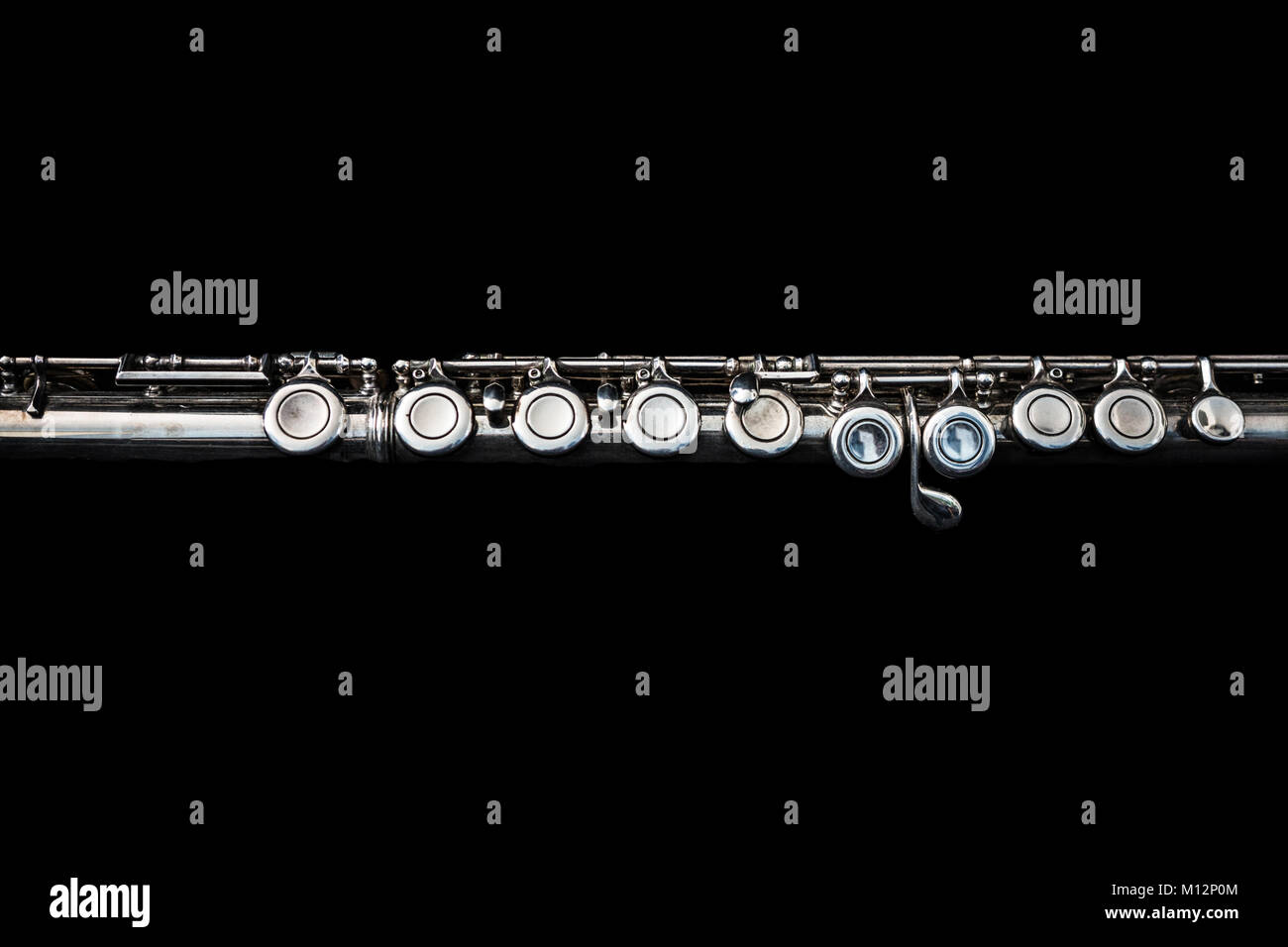 Close up of a transverse flute lying down isolated in black Stock Photo ...