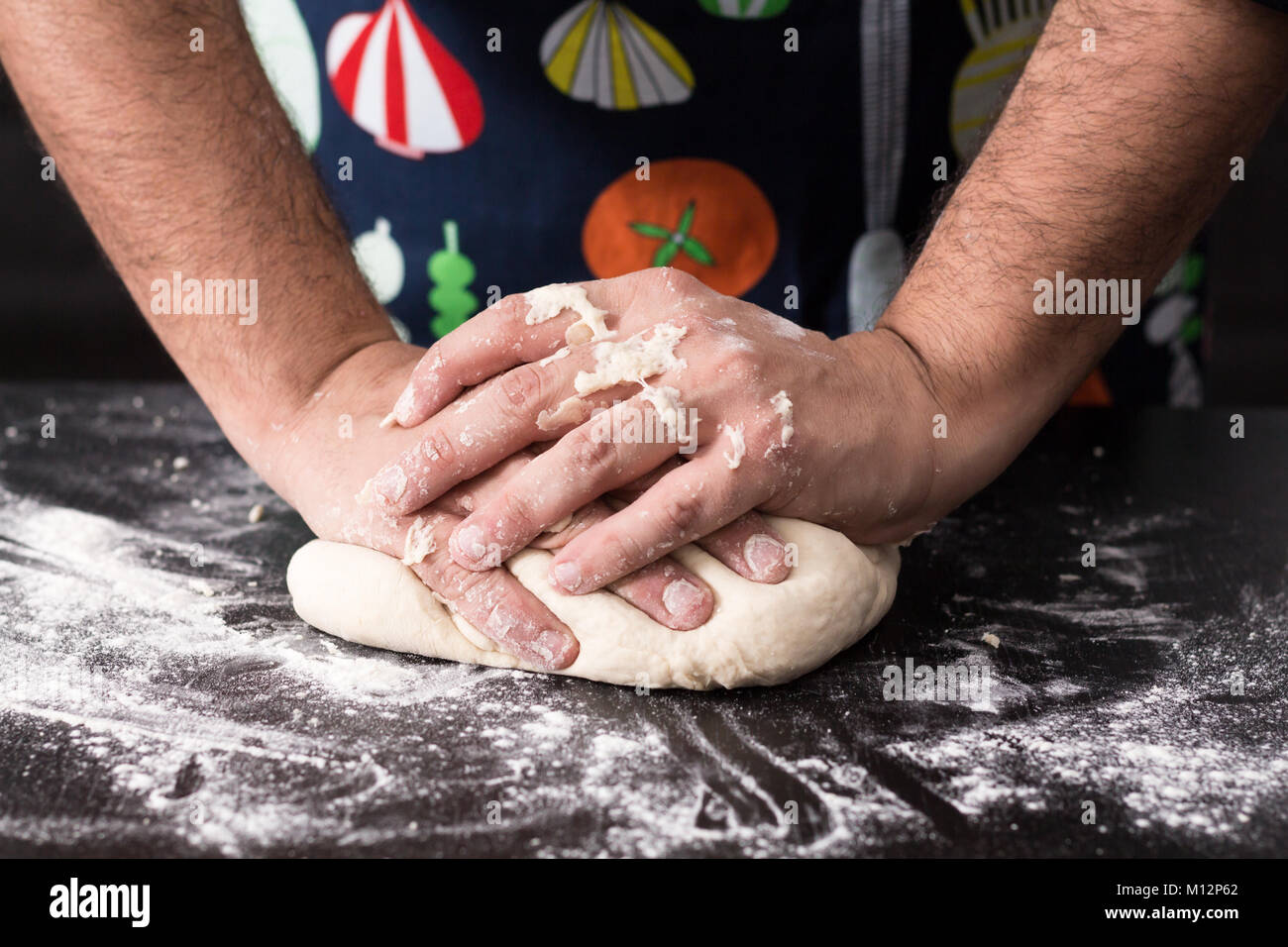 Male hands kneading dough, baking preparation closeup Stock Photo - Alamy