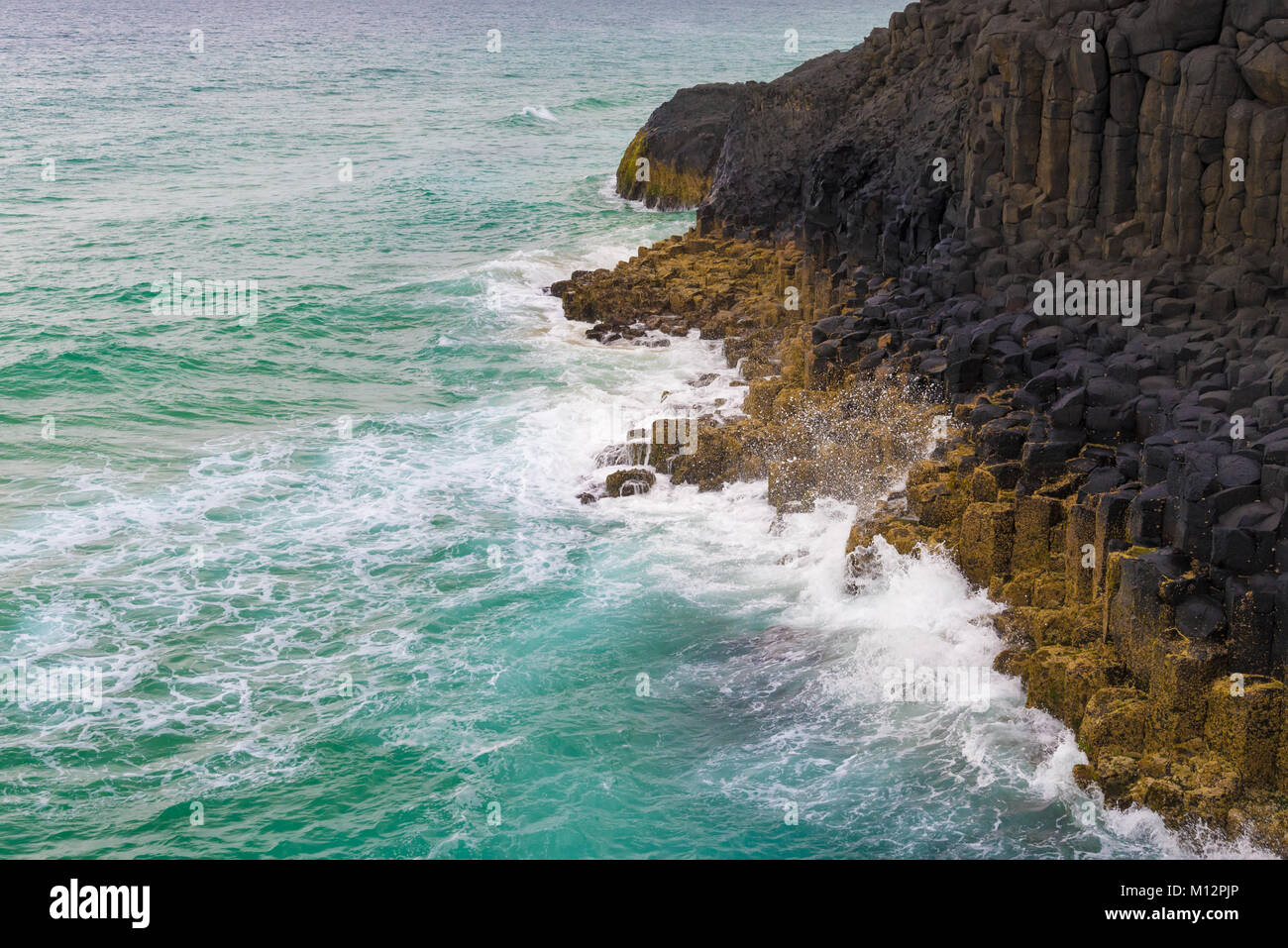 Crescent shaped hexagonal rock formations at Fingal Head, Australia ...