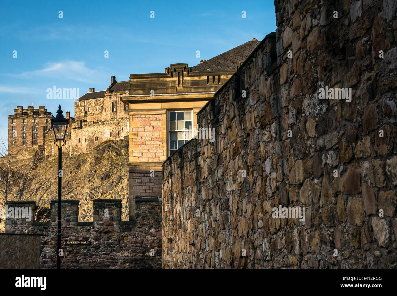 Flodden wall and Vennel alley with Edinburgh Castle rocky outcrop lit ...