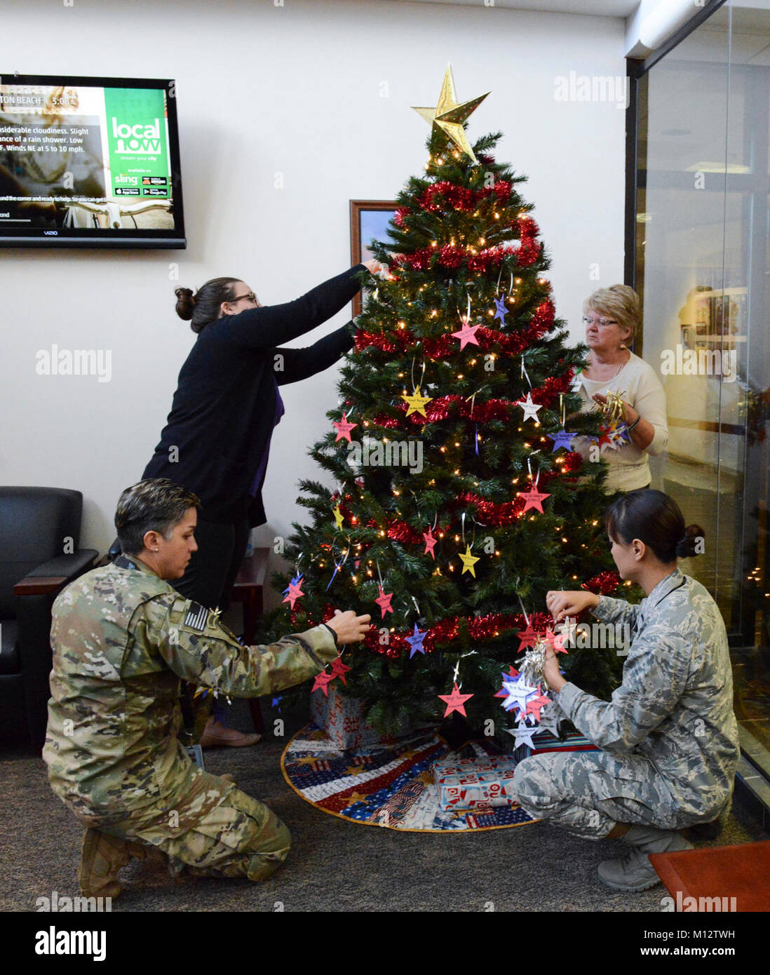 Air Force Special Operations Command members place stars on a Christmas ...