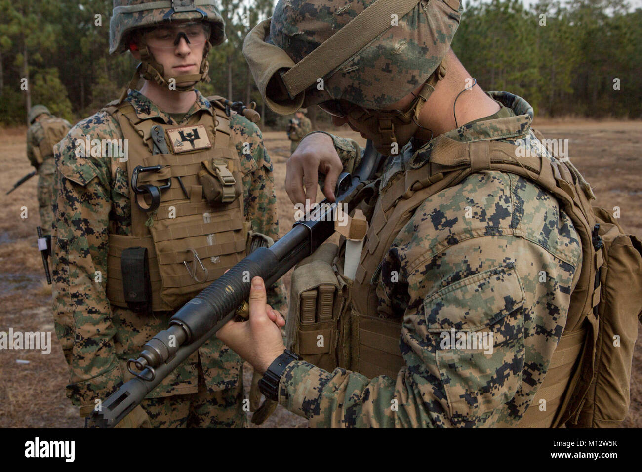 U.S. Marines with 3rd Battalion, 8th Marine Regiment, (3/8) 2d Marine Division, loads a 12-gauge ...