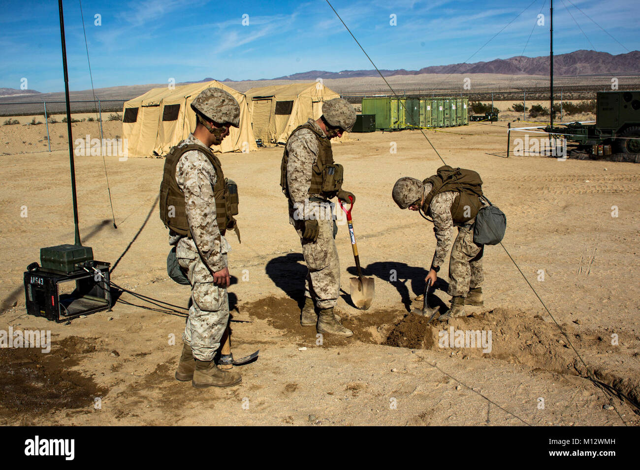 Marines with Marine Wing Communication Squadron 38 dig trenches for ...