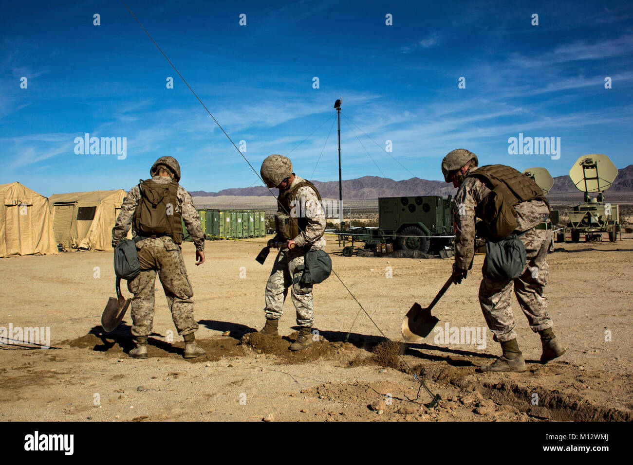 Marines with Marine Wing Communication Squadron 38 dig trenches for ...