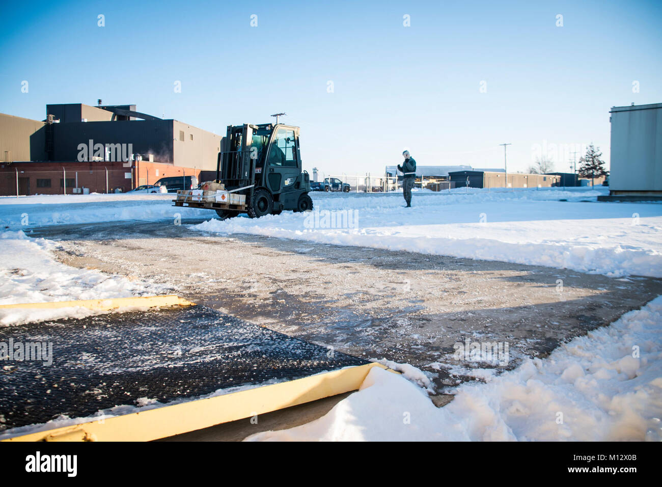 Senior Airman Gregory Butler spots Master Sgt. Adam Hobson during the ...