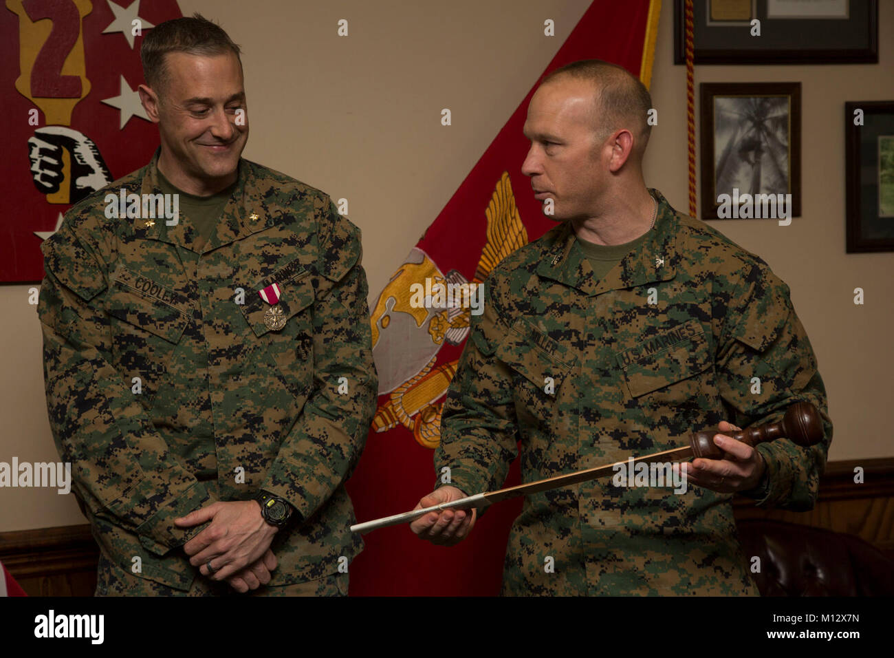 U.S. Marine Corps Maj. Jody L. Cooley, left, receives a gift from Col ...