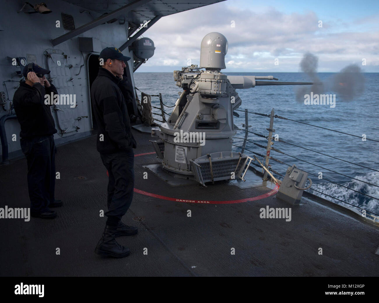 OCEAN (Jan. 21, 2018) Gunner's Mate 1st Class Gregory Bissett, left ...