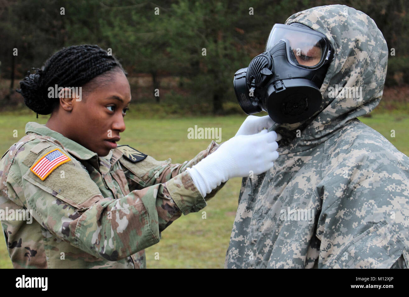 Spc. Airrell Casey, left, helps Spc. Makerita Luani, right, remove her ...