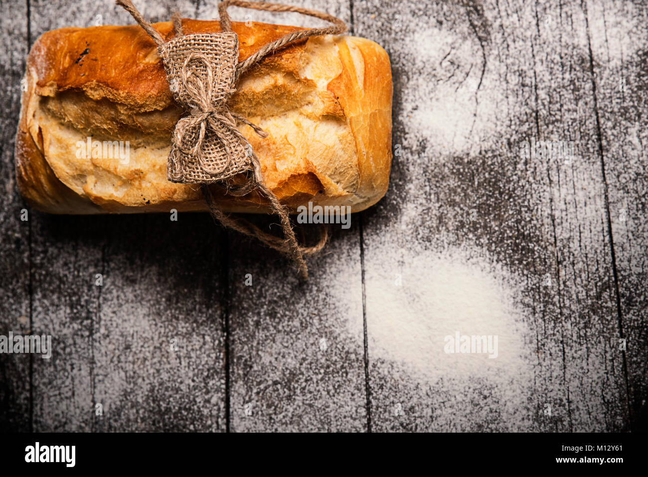 Rustic bread on the old board Stock Photo - Alamy