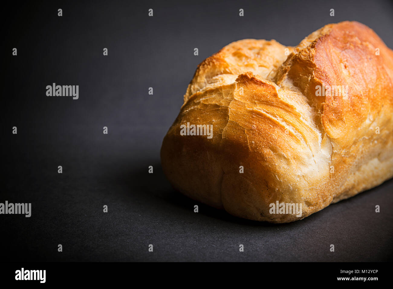 Rustic bread loaf on dark background Stock Photo - Alamy