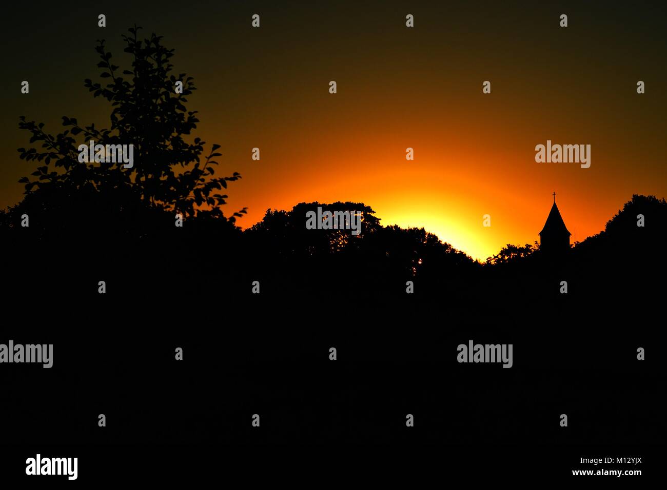 A sunset over a church Stock Photo - Alamy
