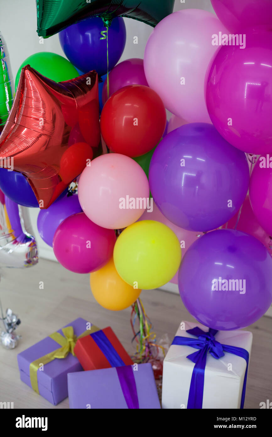 multi-colored balloons and gifts for the holiday Stock Photo - Alamy