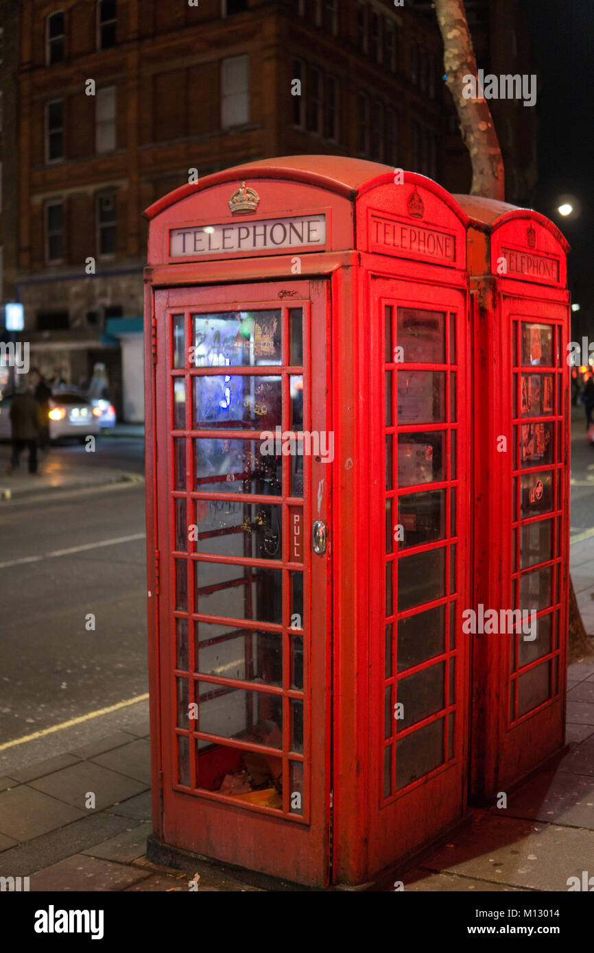 Red Telephone Box in the night in London with light reflections Stock ...