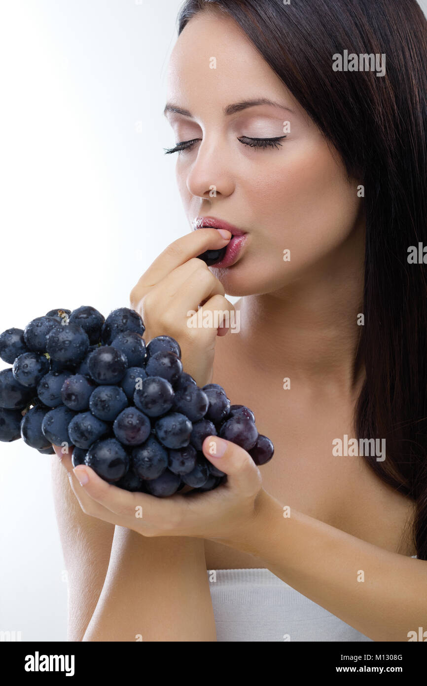 Woman eating grapes hi-res stock photography and images - Alamy