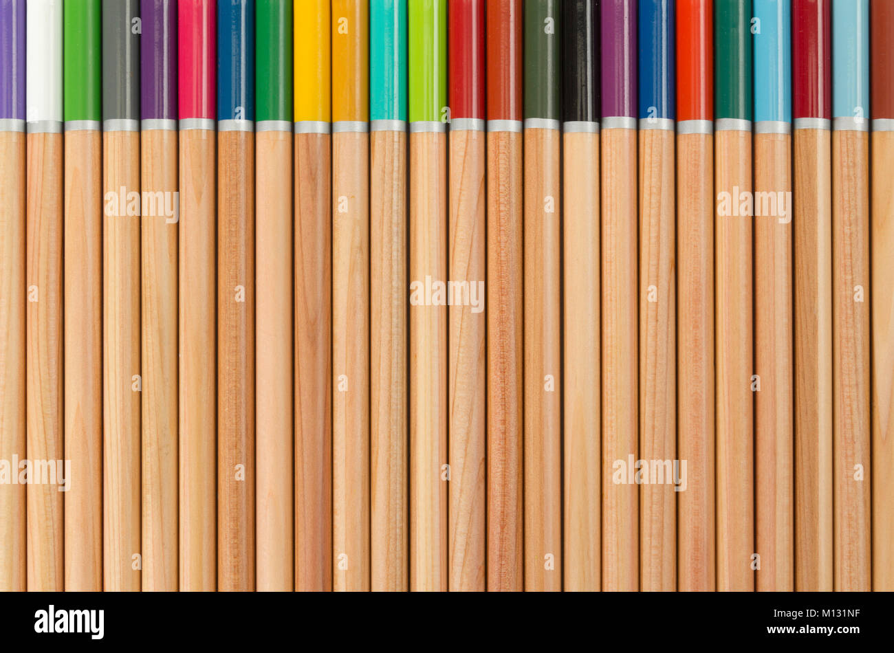 Artists watercolour pencils on a textured white paper surface, the wood ...