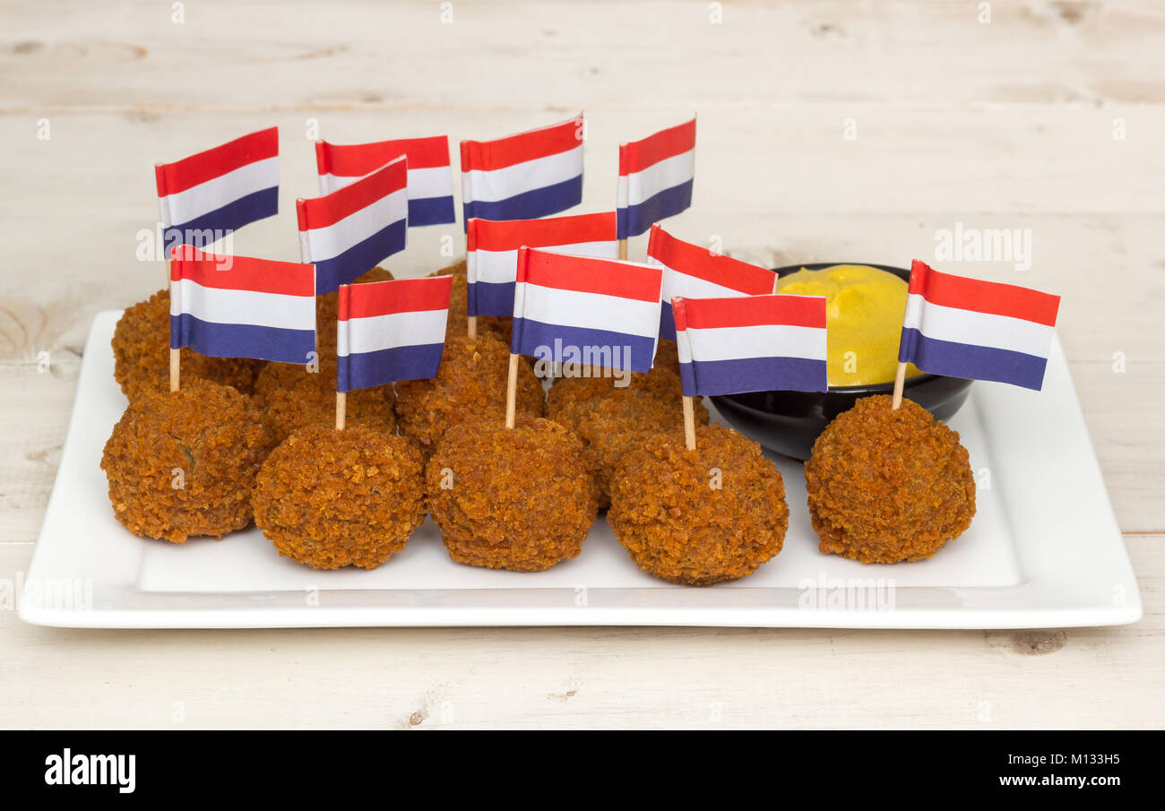 Dutch snack bitterballen with little dutch flags on a white plate Stock ...