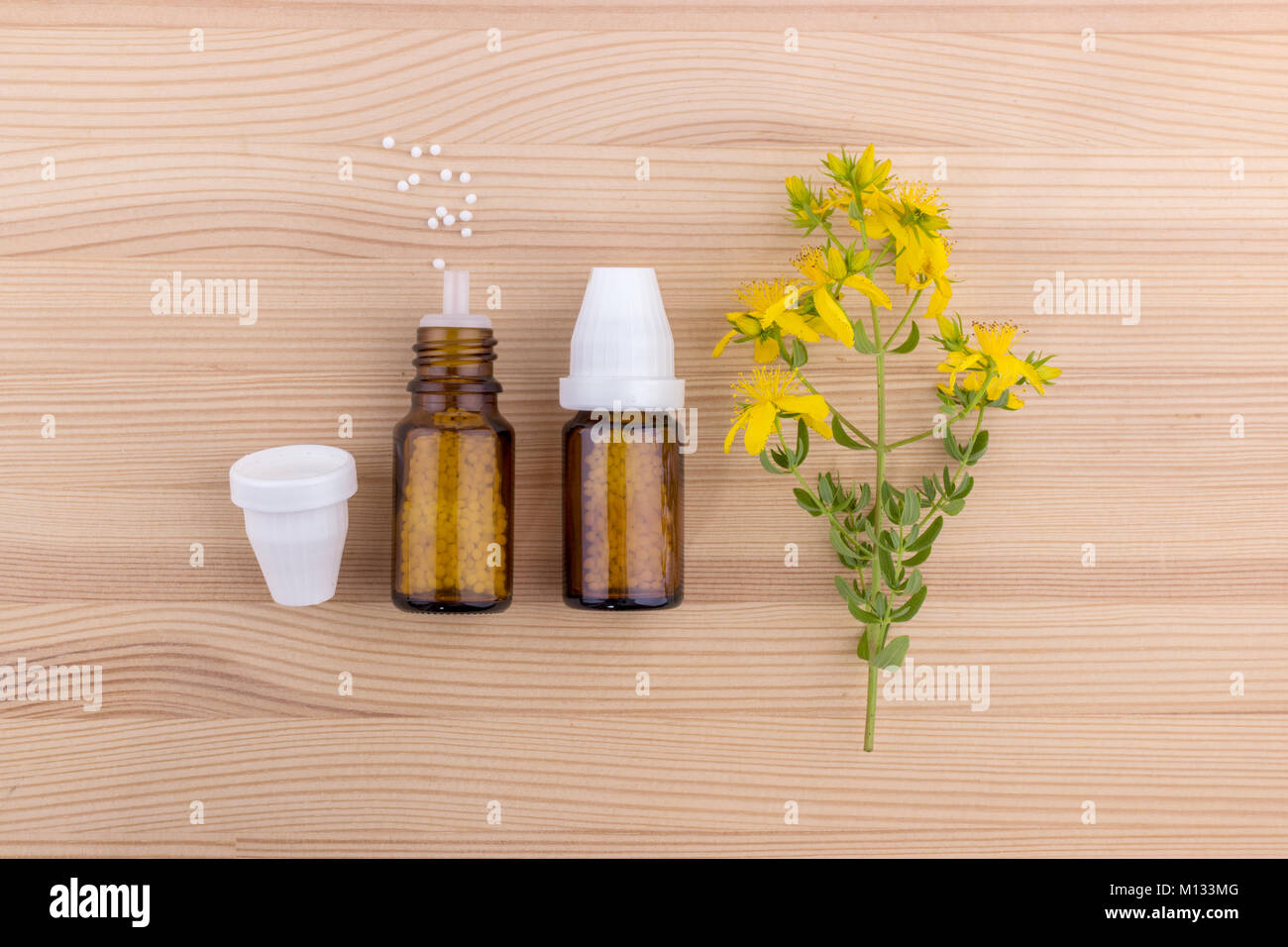 Top view of a homeopathic medicine with blooming St. John's wort on a ...