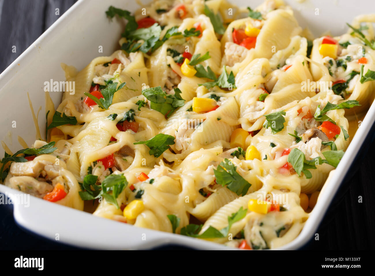 Baked shells conchiglioni pasta stuffed with chicken, mushrooms and ...