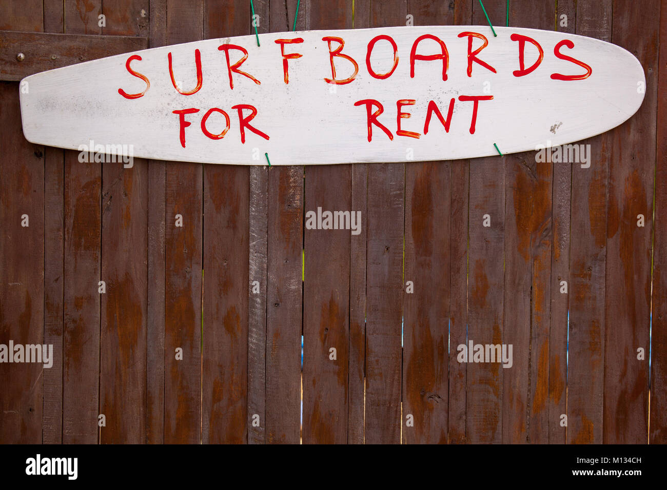 A hand made wooden sign saying surf boards to rent, taken in Cost Rica ...
