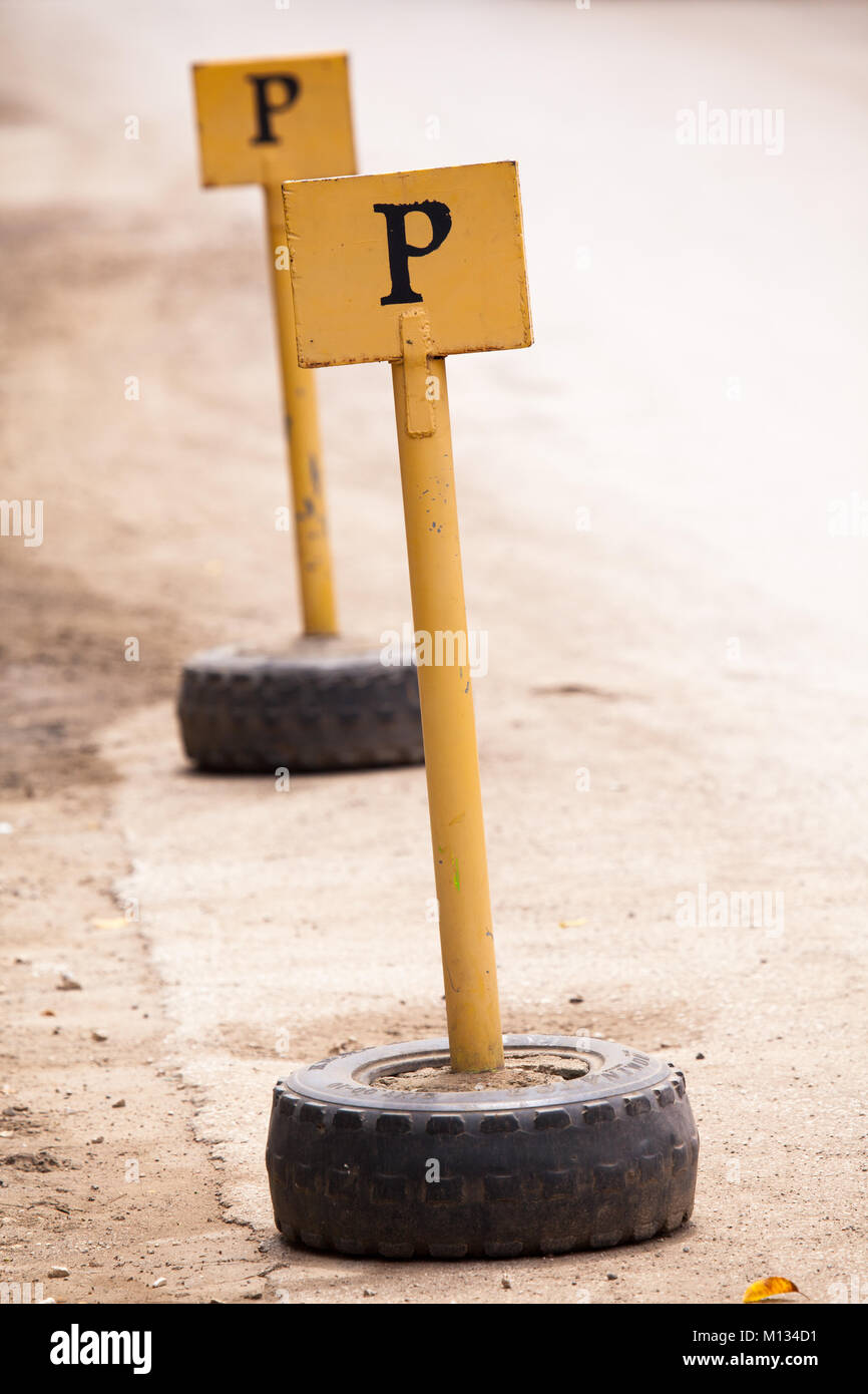 Simple parking signs made from poles and used tyres Stock Photo - Alamy