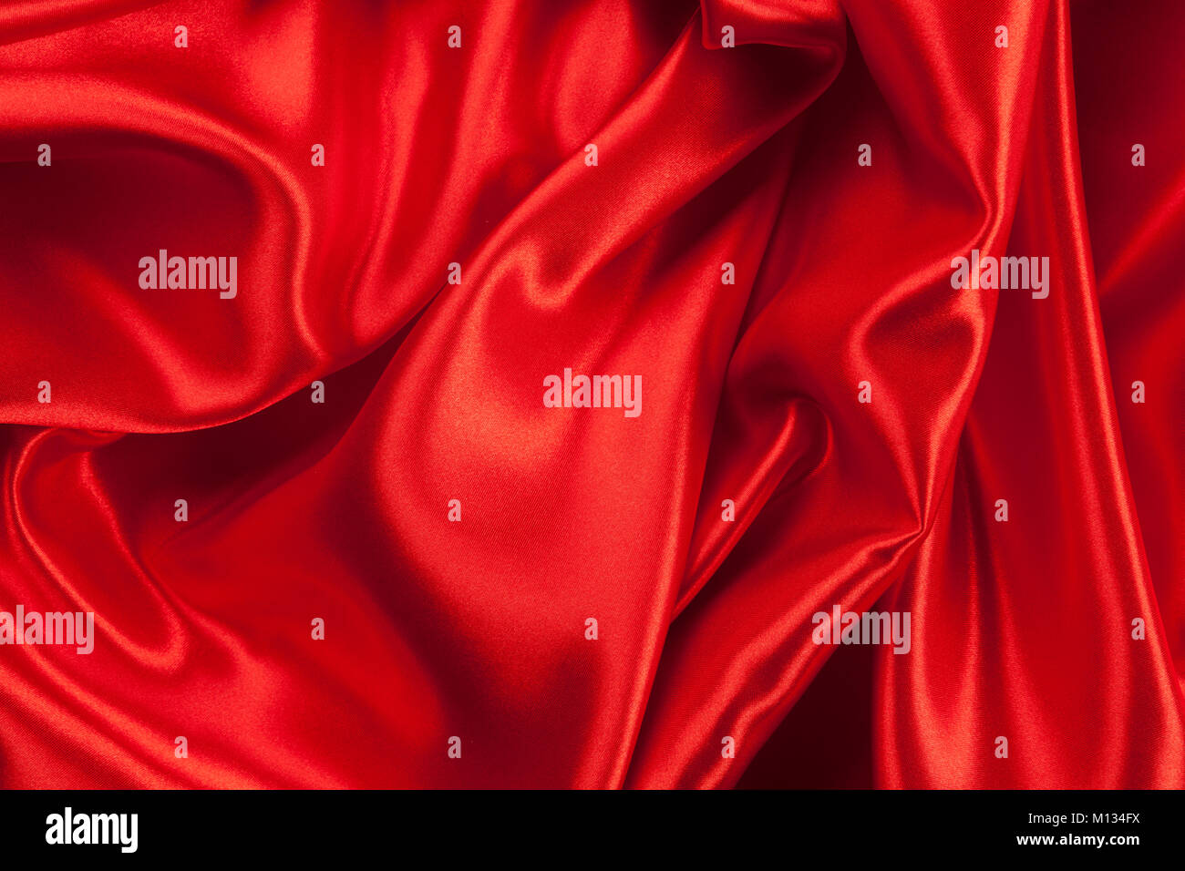 close-up view of a red piece of satin fabric. Minimal color still life ...
