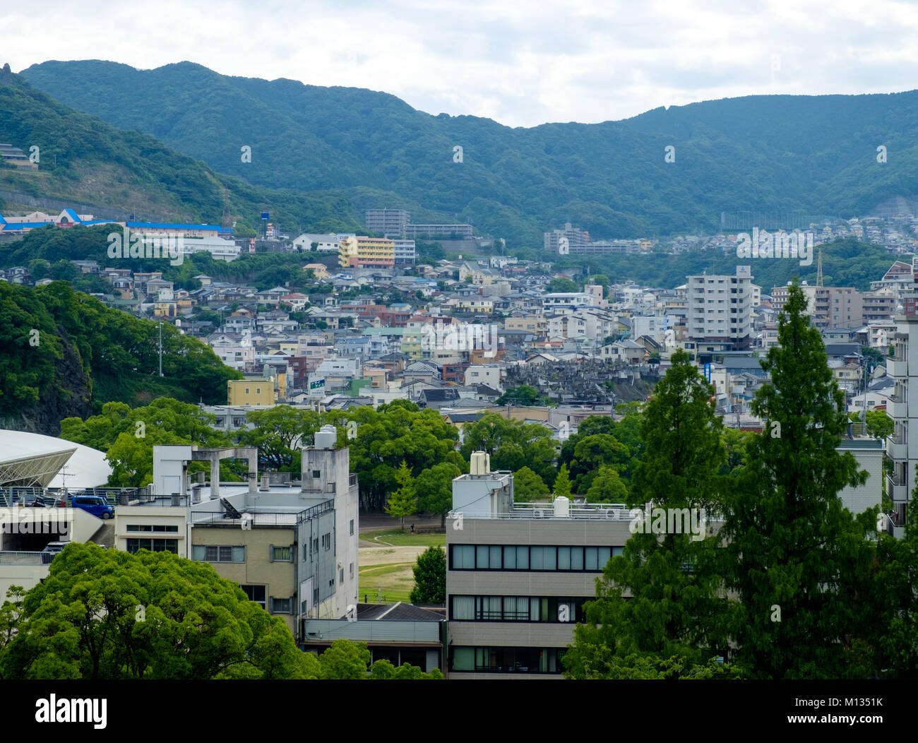 Bird's eye view of the city of Nagasaki with two buildings and trees in ...