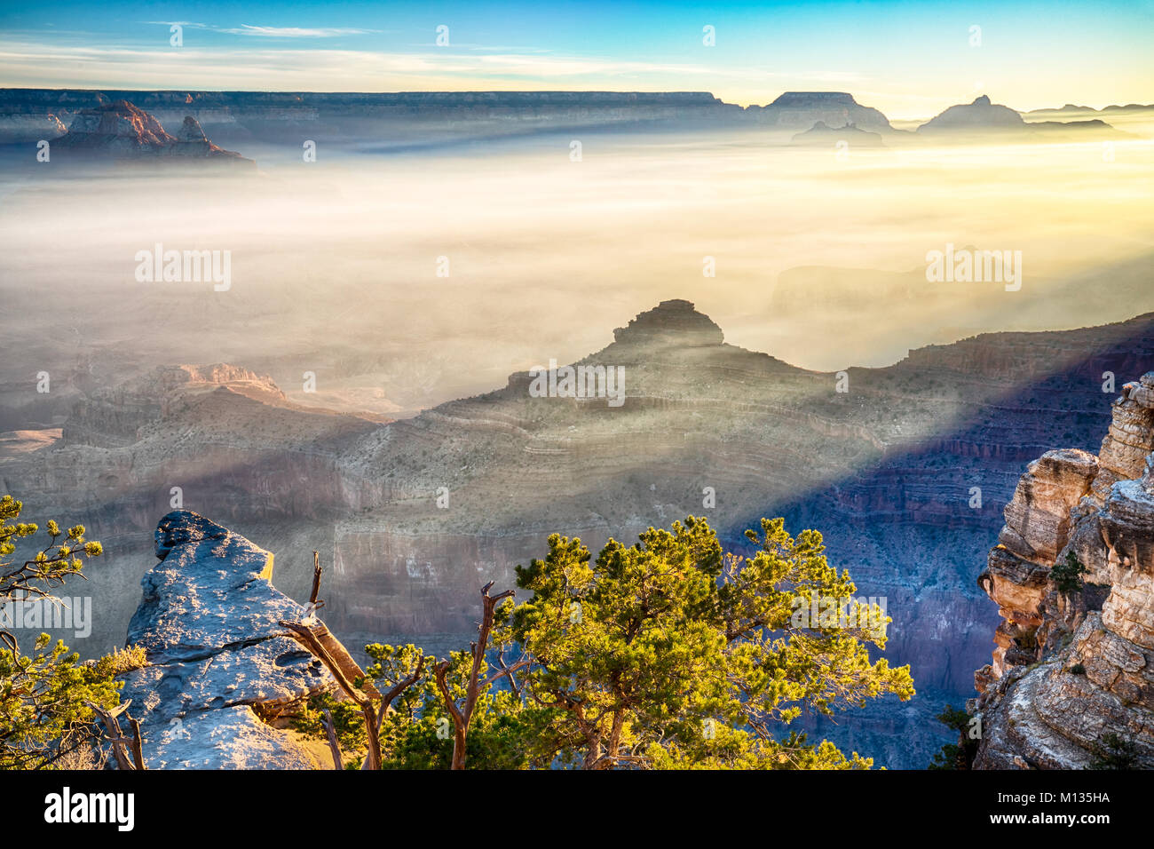 Rays of sunlight across the morning fog in Grand Canyon, Arizona from ...