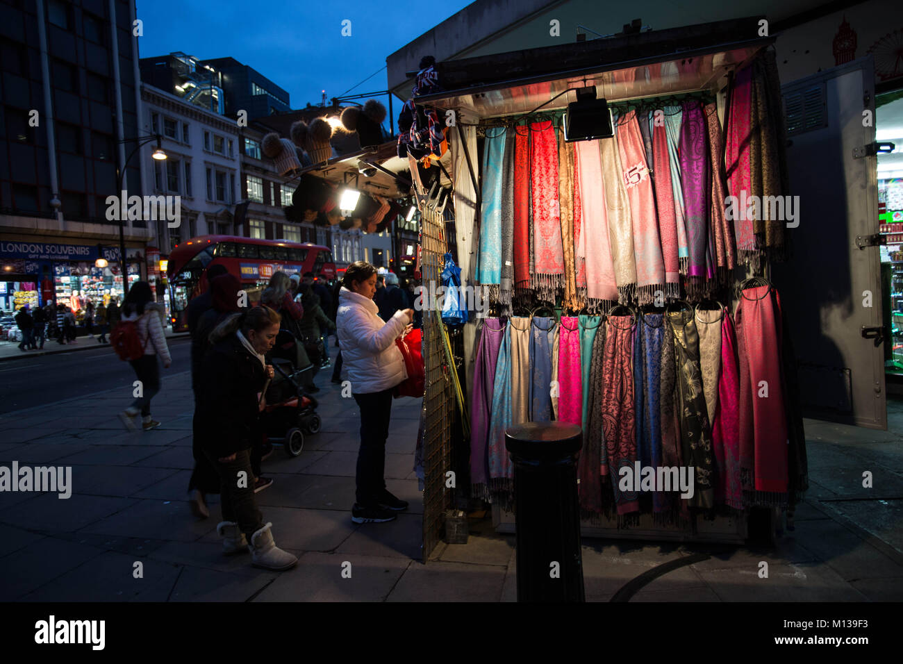 London, UK. 22nd Jan, 2018. People seen buying clothes from a street ...