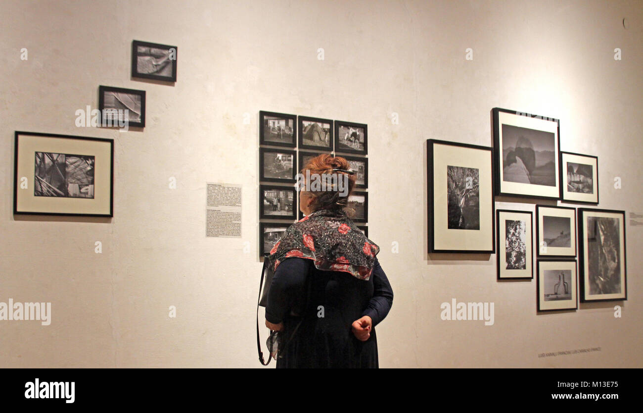 A visitor studying works at the exhibition "The World with Minox" at ...