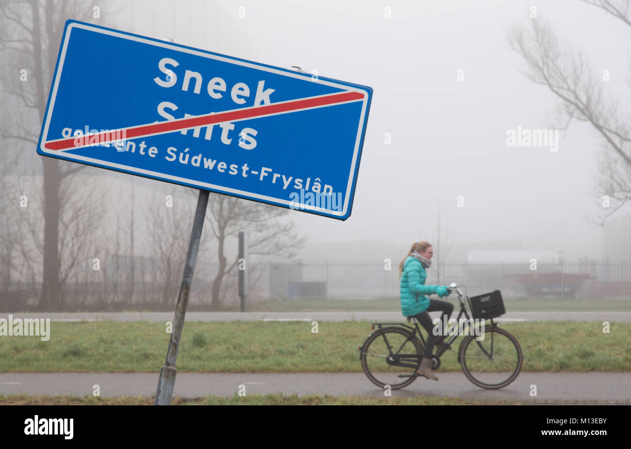 A cyclist passes the exit sign of the Dutch town Sneek in the ...
