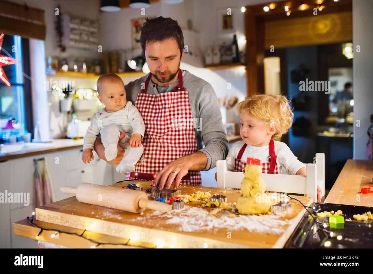 Young family making cookies at home Stock Photo - Alamy
