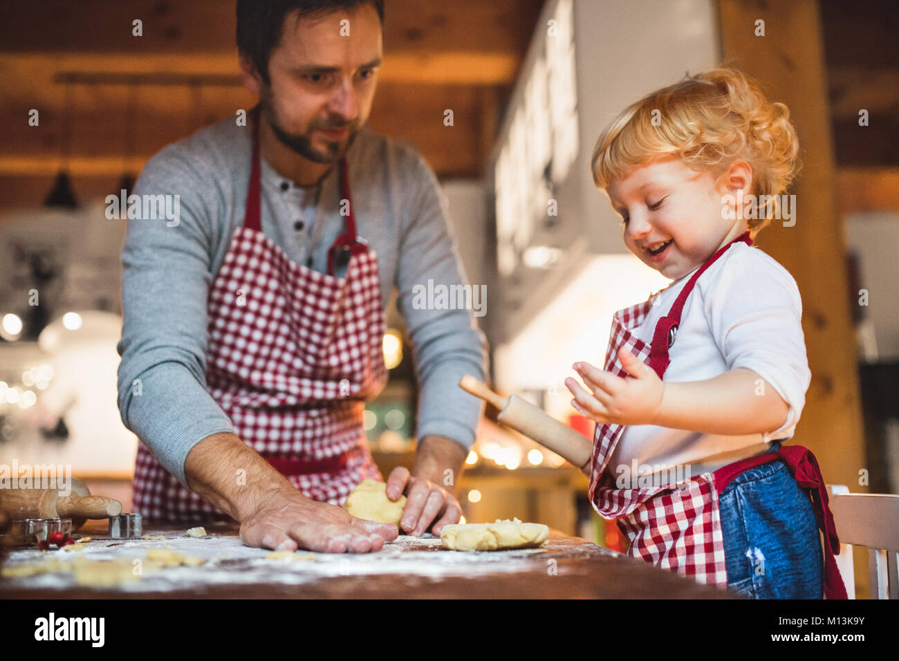 Young family making cookies at home Stock Photo - Alamy