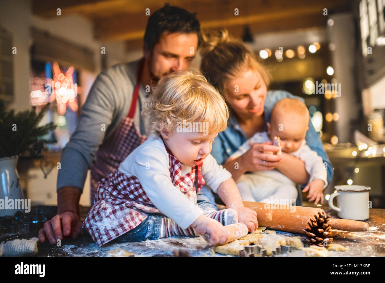 Young family making cookies at home Stock Photo - Alamy