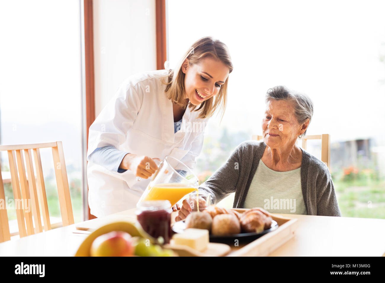 Health visitor and a senior woman during home visit Stock Photo - Alamy