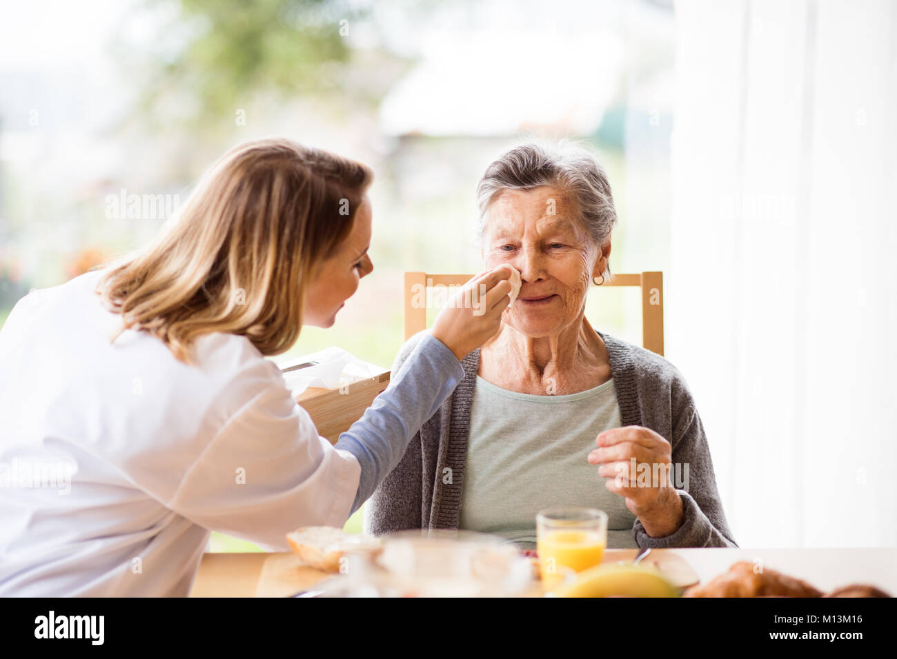 Health visitor and a senior woman during home visit Stock Photo - Alamy