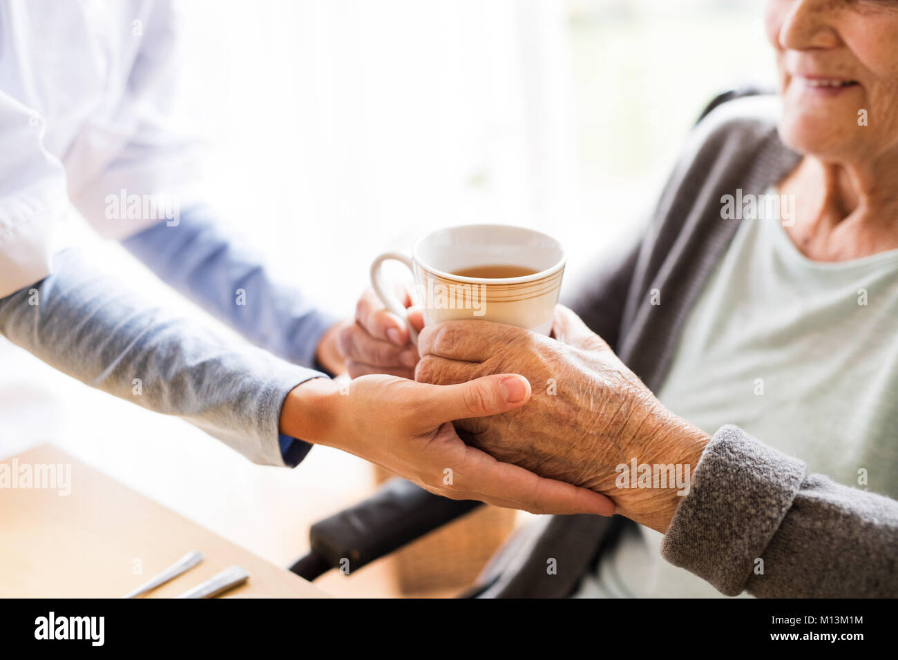 Health visitor and a senior woman during home visit Stock Photo - Alamy