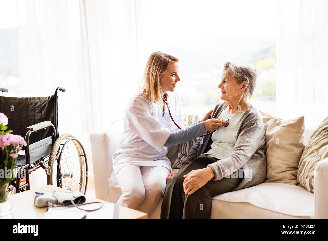 Health visitor and a senior woman during home visit Stock Photo - Alamy